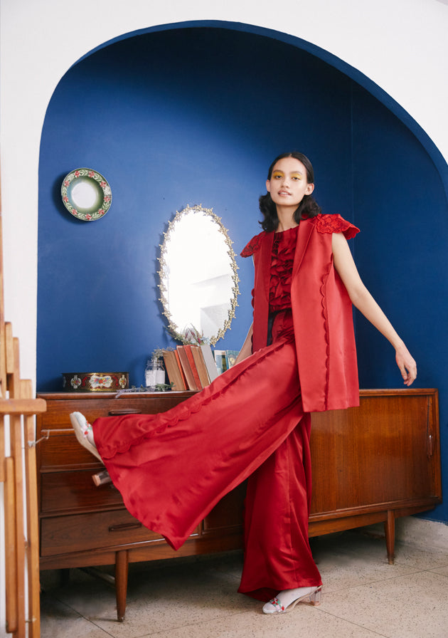 Red satin flared pants with scallop detailing